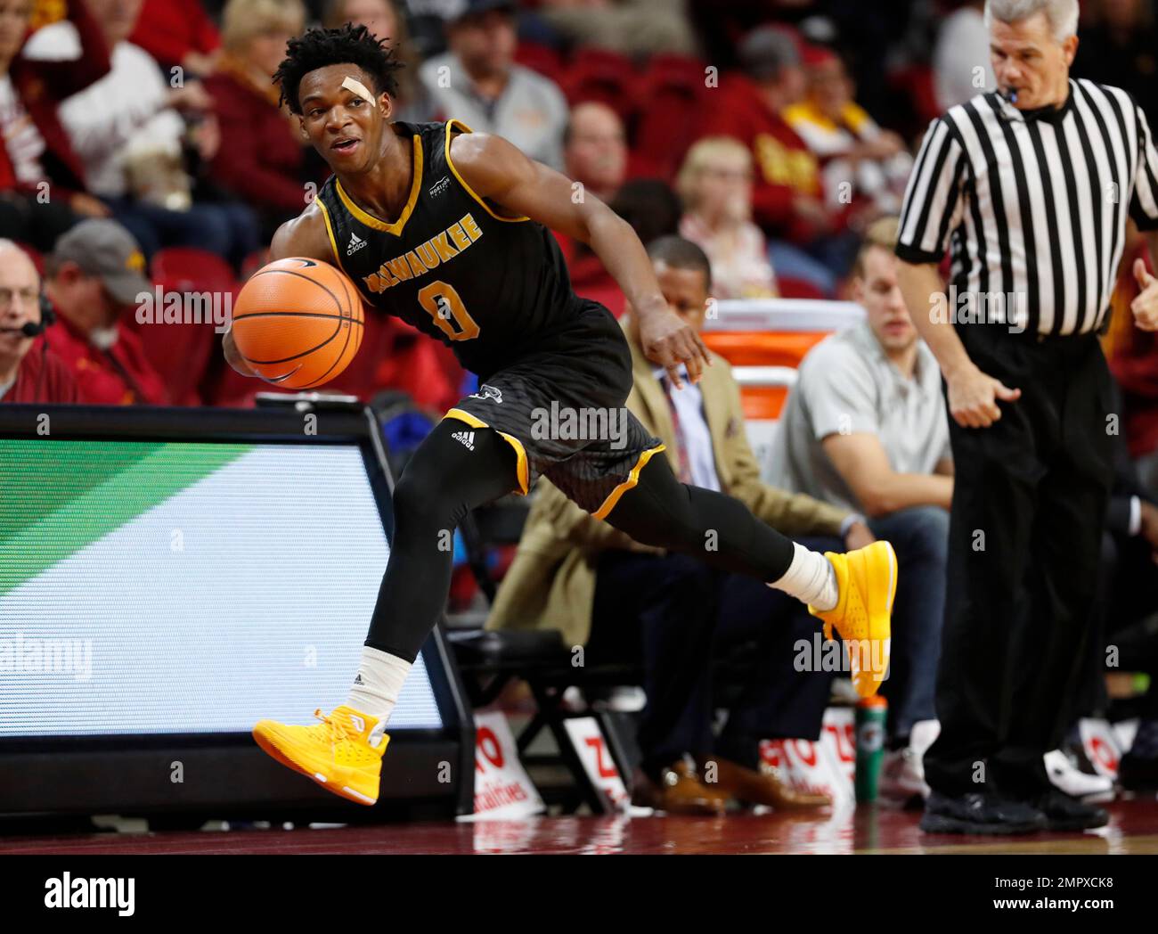 Milwaukee guard Bryce Barnes saves the ball from going out of bounds ...