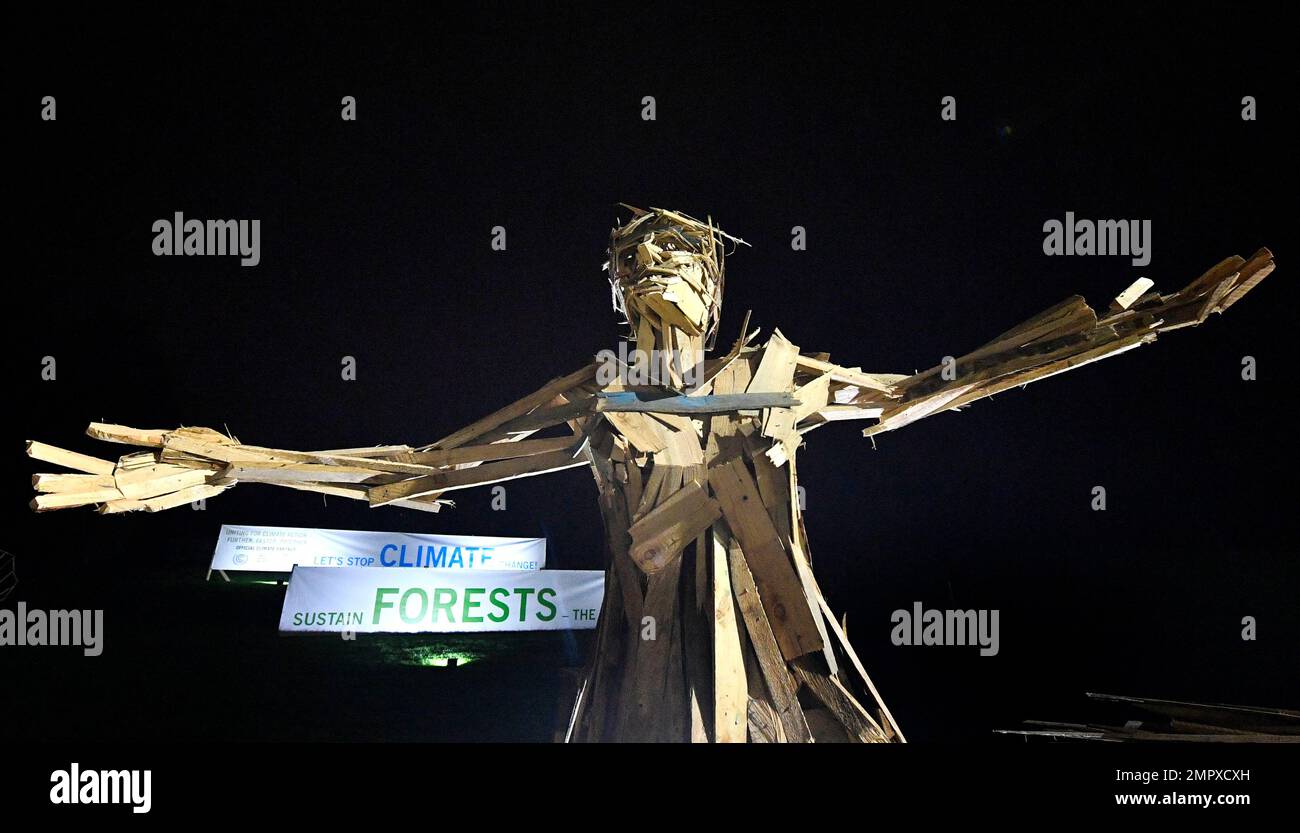 A statue made of old wood is seen during protests outside the COP 23 ...