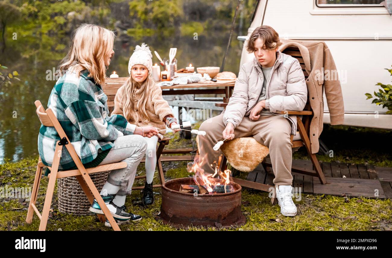 Children,family,brother sister fry marshmallows on fire. Picnic in ...