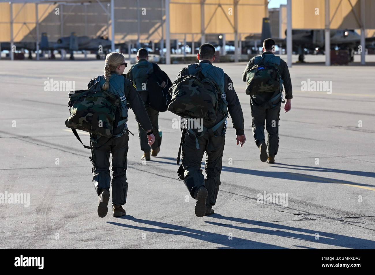 A group of U.S. Air Force pilots, assigned to the 357th Fighter Squadron, walk onto the flight ...