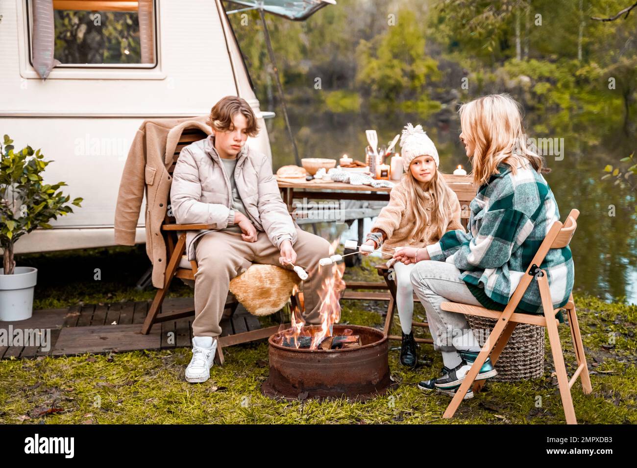 Children,family,brother sister fry marshmallows on fire. Picnic in ...
