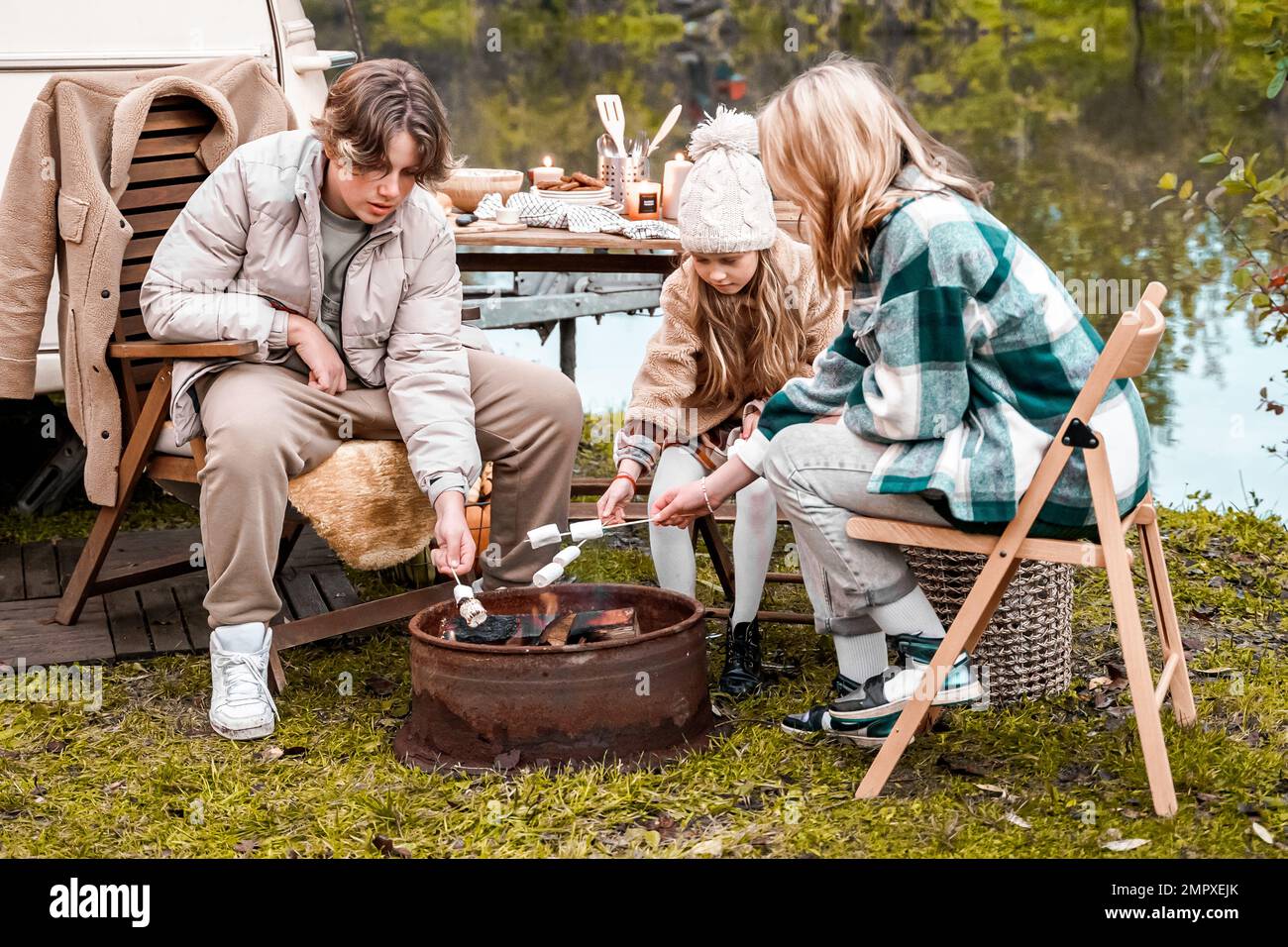 Children,family,brother sister fry marshmallows on fire. Picnic in ...