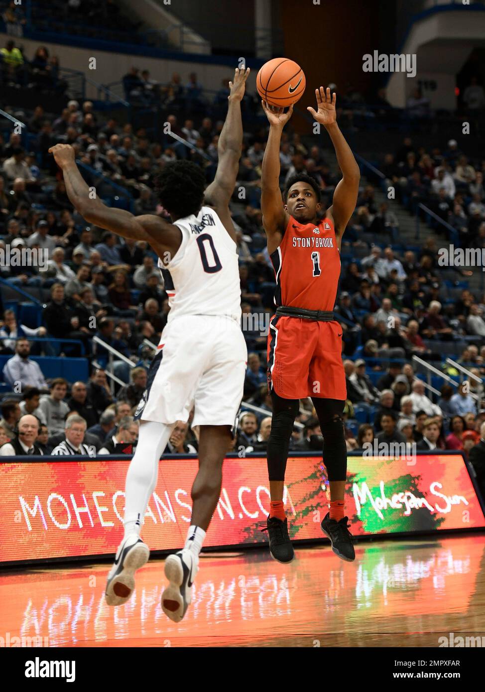Stony Brook's UCIroegbu shoots over Connecticut's Antwoine Anderson ...