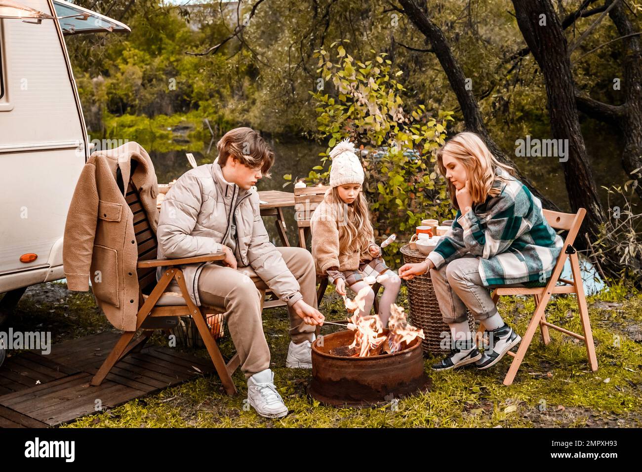 Children,family,brother sister fry marshmallows on fire. Picnic in ...
