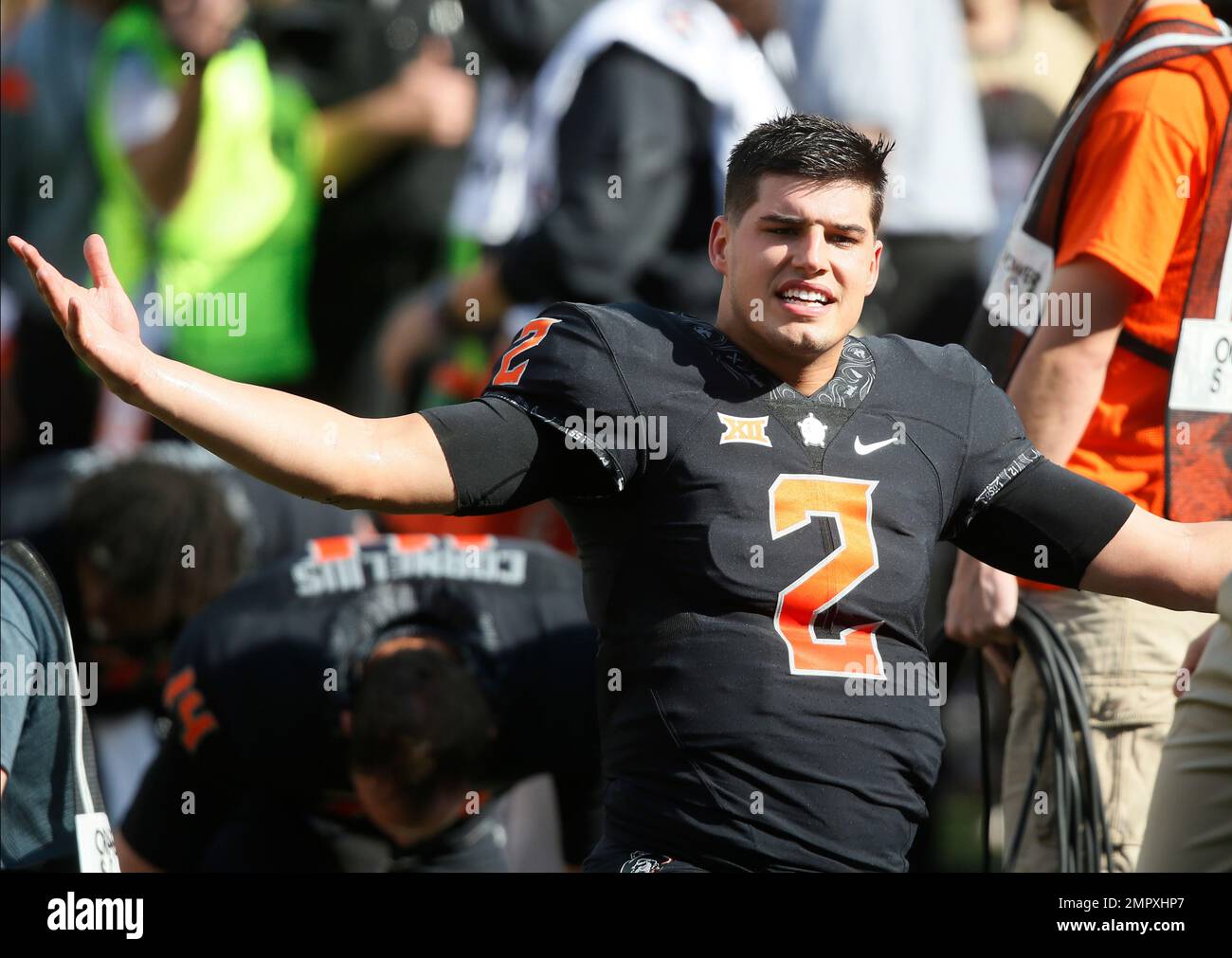 Oklahoma State quarterback Mason Rudolph stretches before an NCAA ...