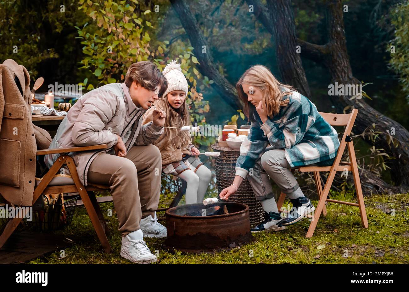 Children,family,brother sister fry marshmallows on fire. Picnic in ...