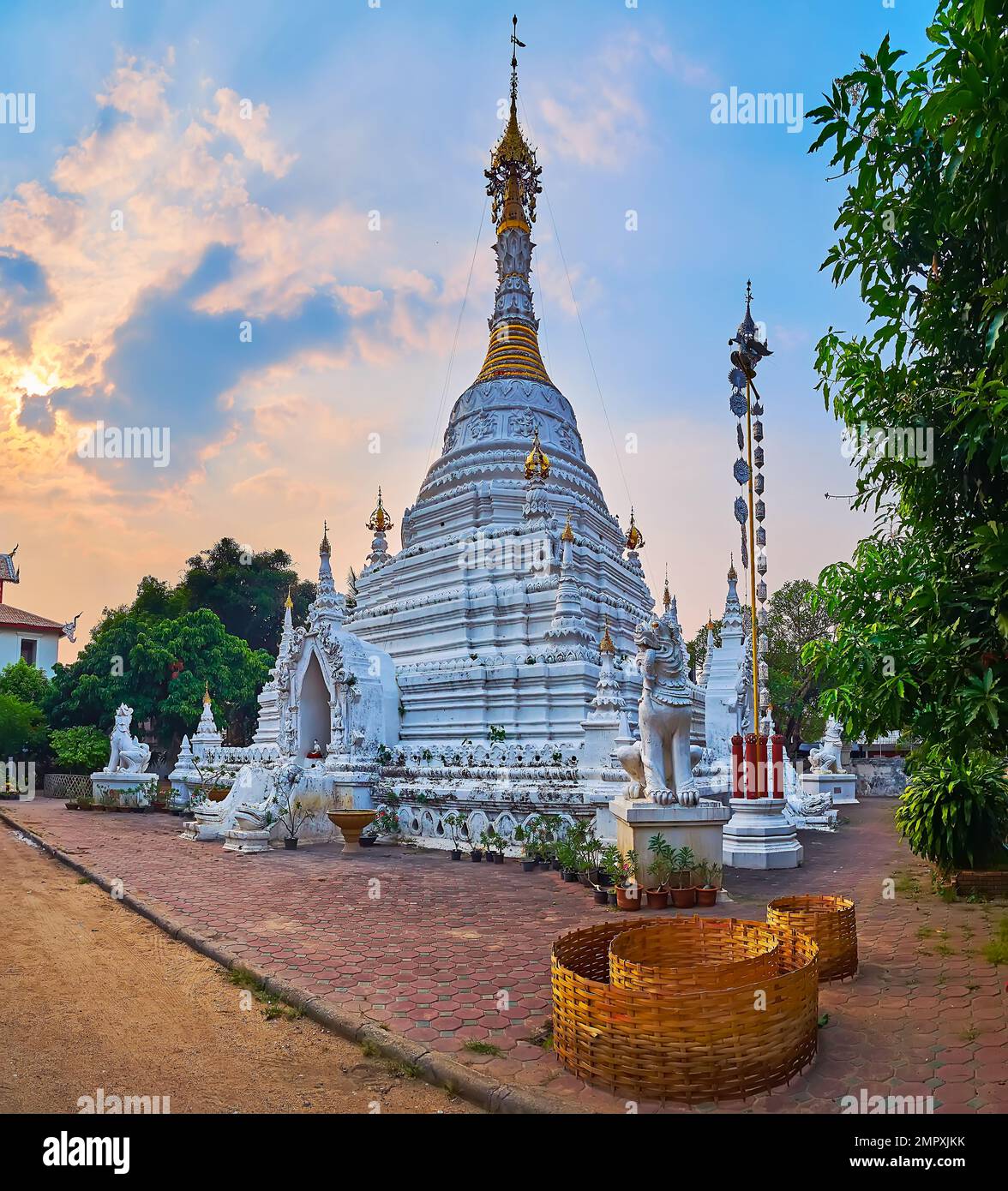 The sculptured white stucco Chedi of Wat Mahawan, topped with golden ...