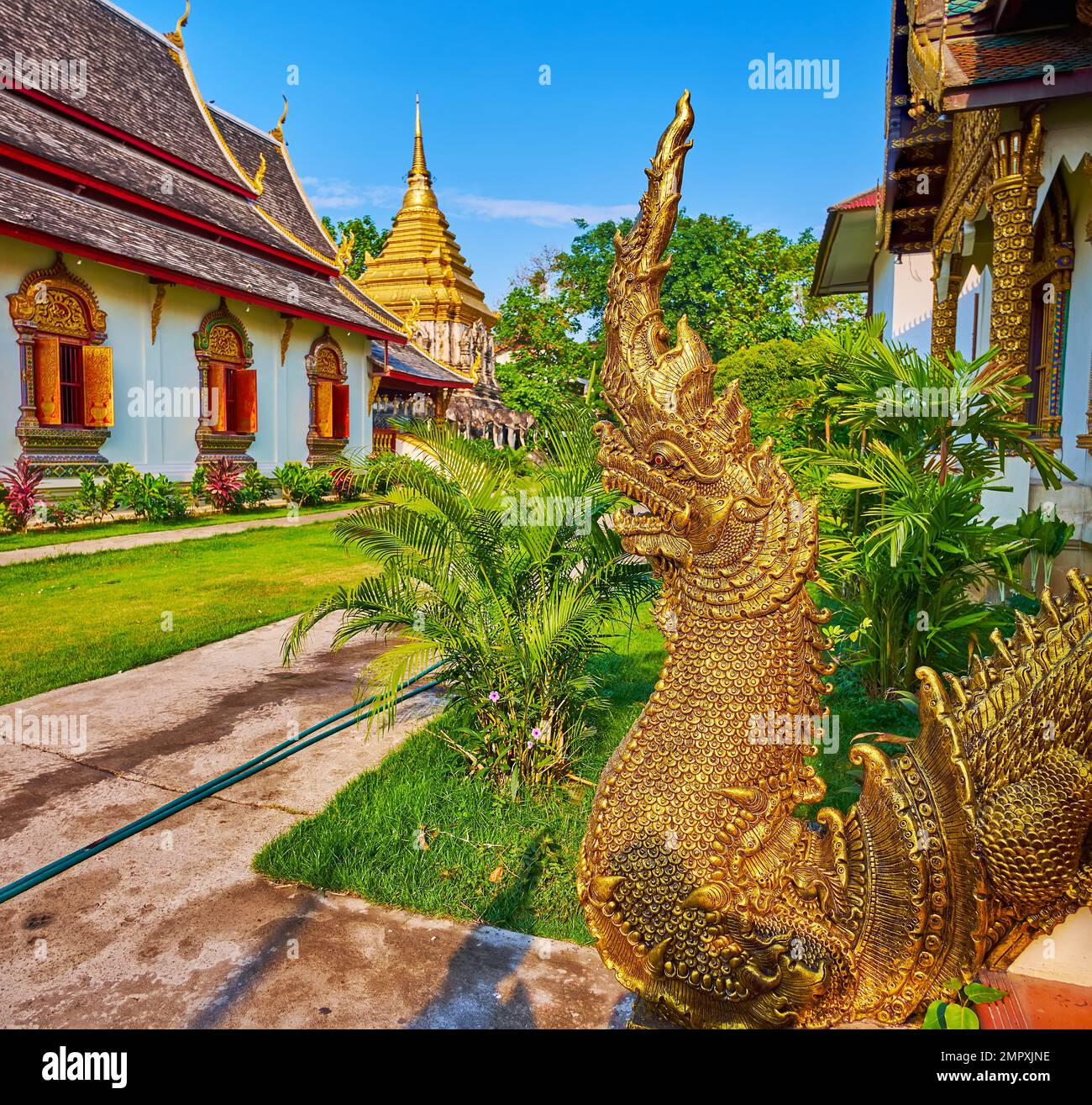 Carved gilt statue of Makara crocodile and Naga serpent against the ...