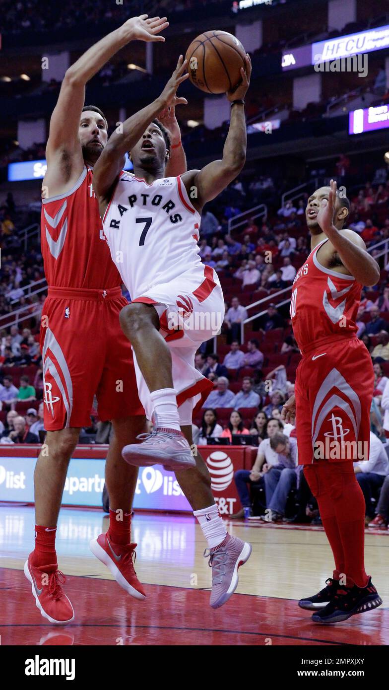 Toronto Raptors guard Kyle Lowry (7) puts up a shot between Houston ...