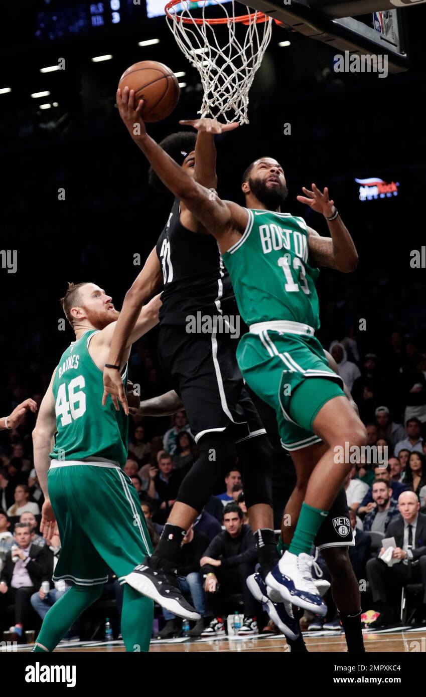 Boston Celtics' Marcus Morris (13) drives past Brooklyn Nets' Jarrett ...