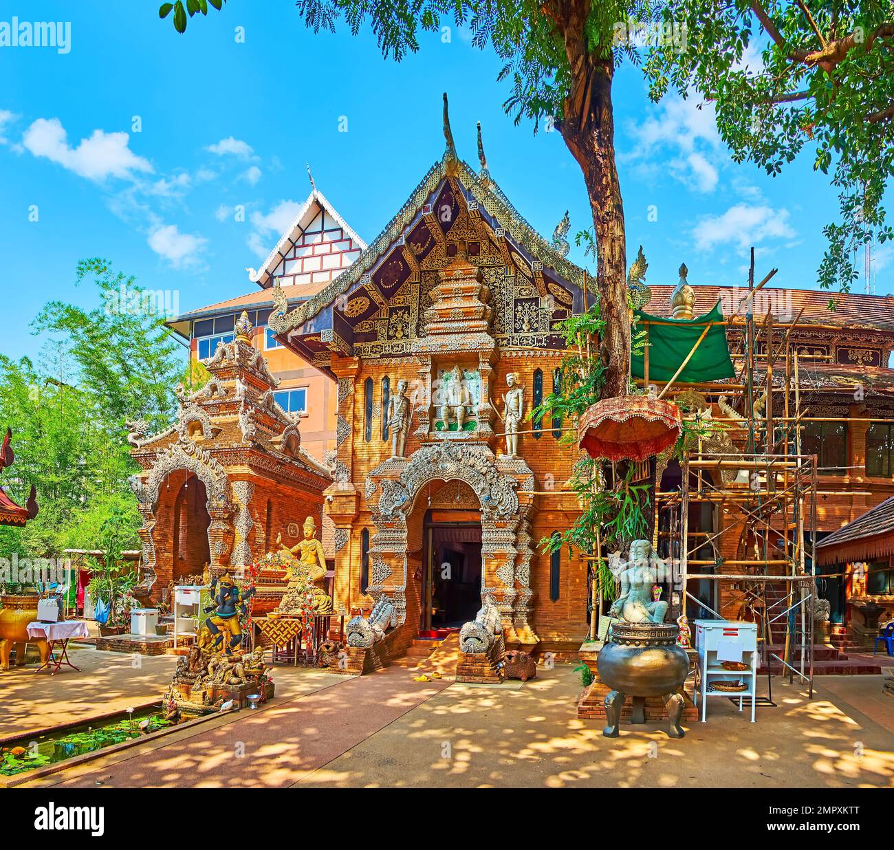 The richly decorated carved multi-purpose building in Wat Lok Moli with ...