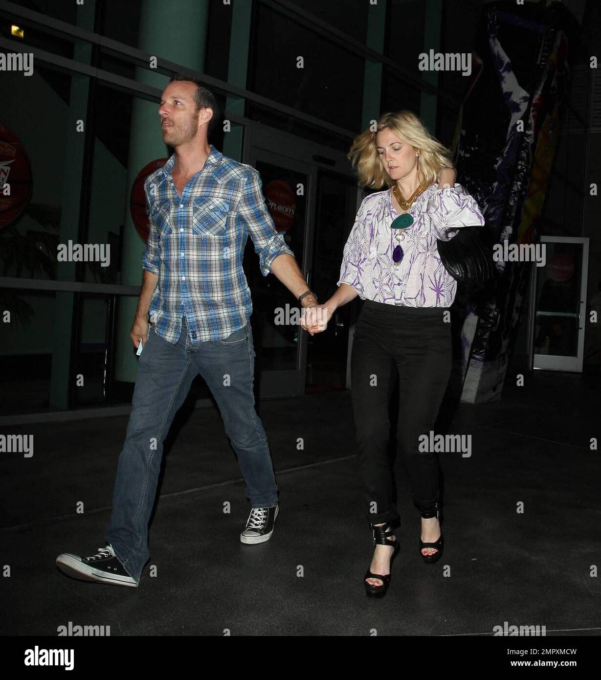 Drew Barrymore and a mystery man hold hands on the way into see a ...