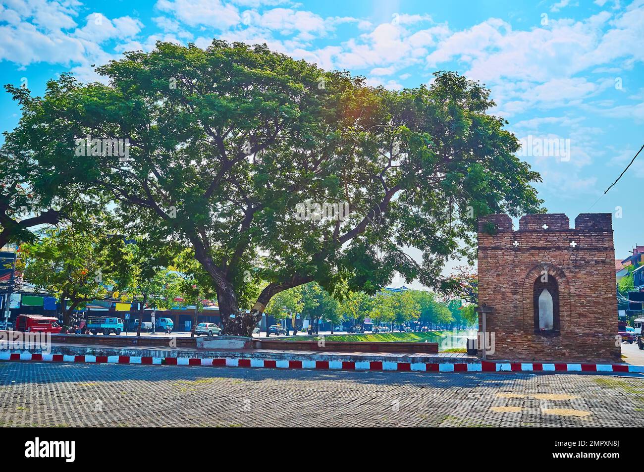 The lush green tree and brick ruins of Chang Phuak Gate on the Old City ...