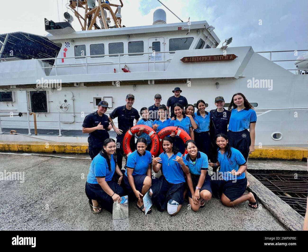 The crew of USCGC Frederick Hatch (WPC 1143) take a moment in the rain ...