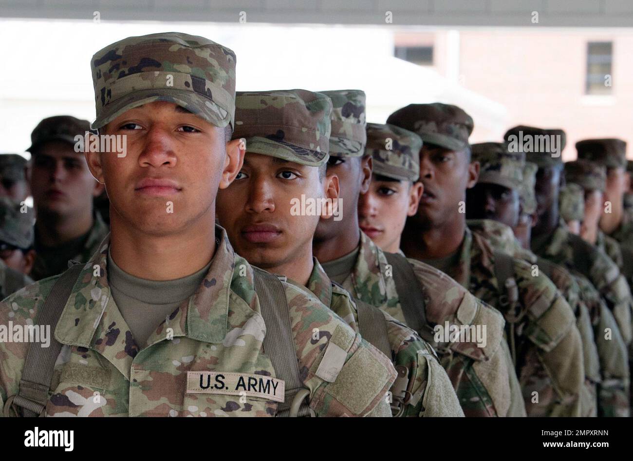 Trainees with 1st Battalion, 61st Infantry Regiment, line up to enter ...