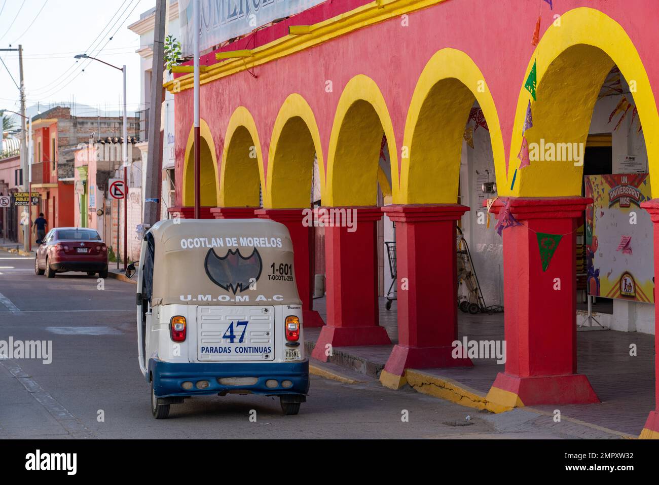 A mototaxi and colorful arched arcade in the market town of Ocotlan de ...