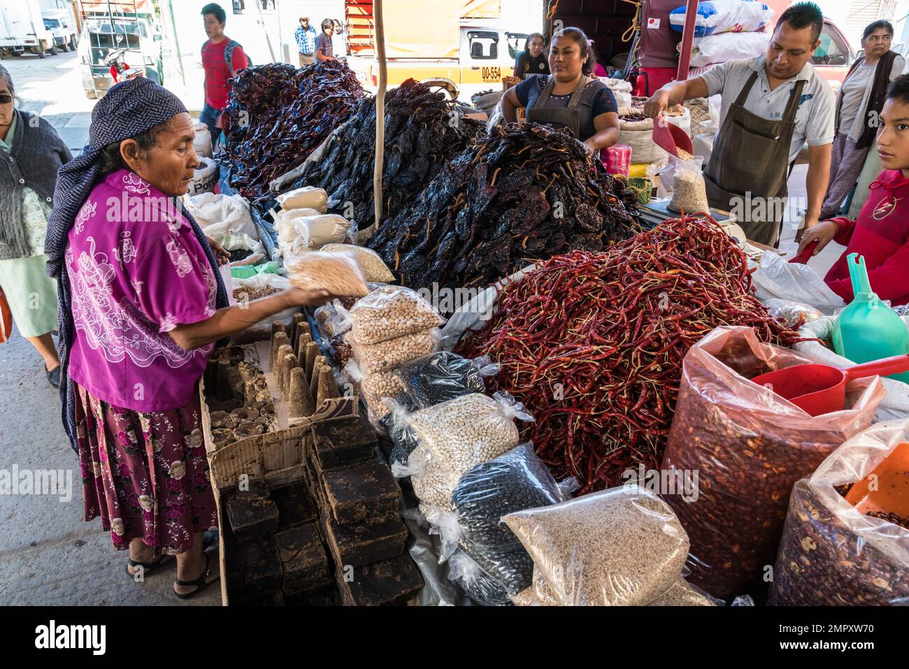 An indigenous Zapotec woman buys a bag of beans in the market in ...