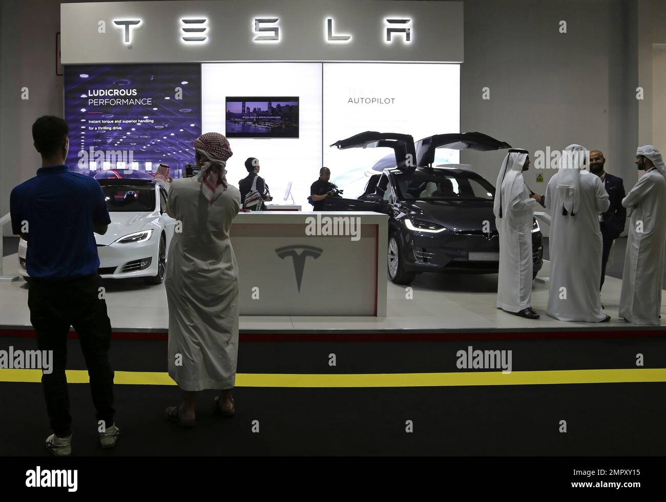 People visit the Tesla stand at the Dubai Motor Show in the United Arab ...