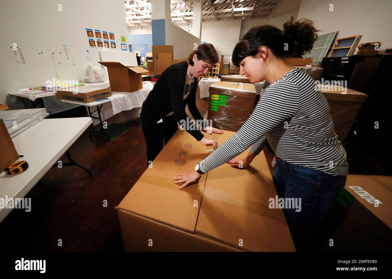 In this Tuesday, Nov. 7, 2017, photograph, museum move assistants Laura ...