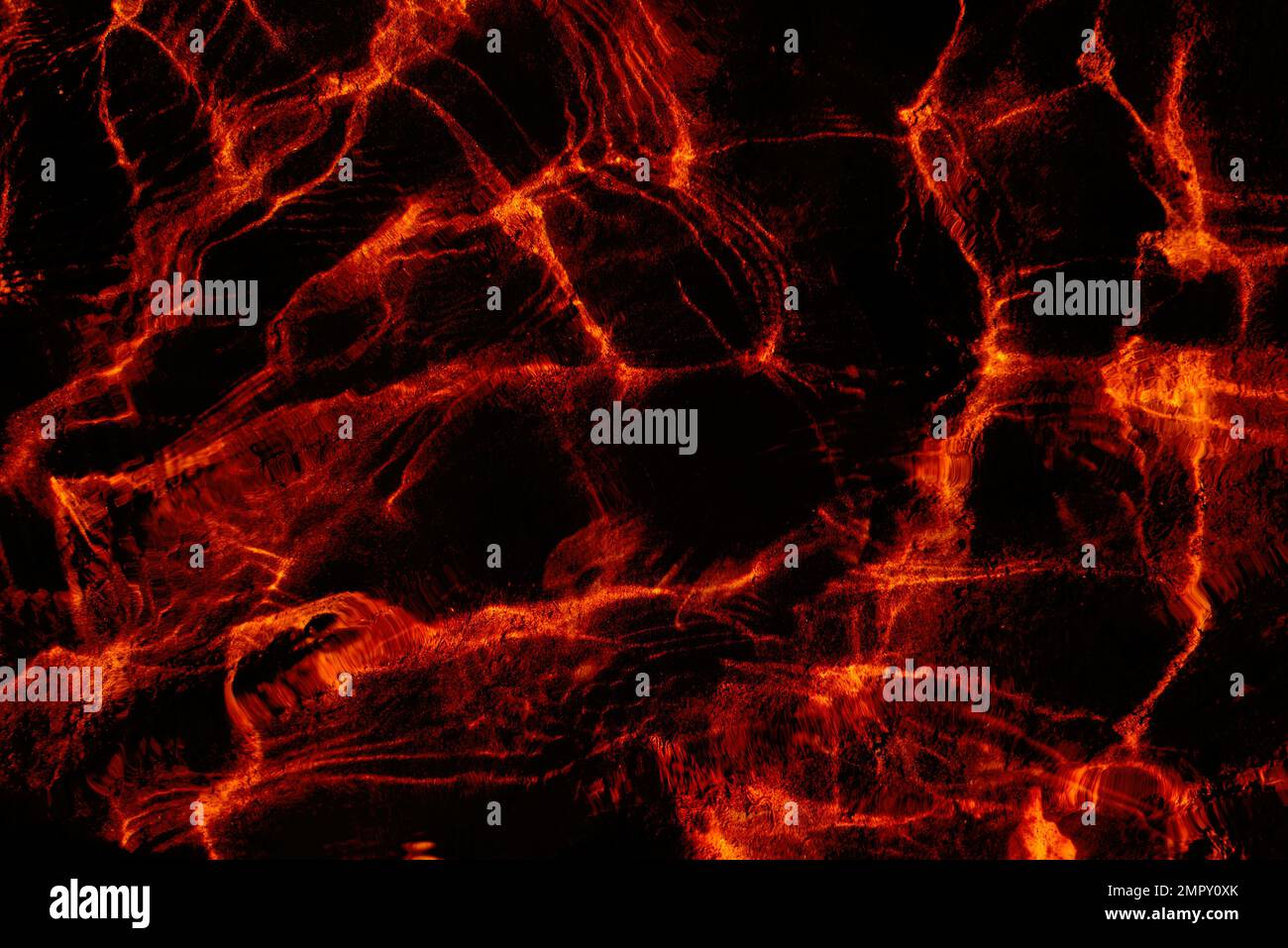 Abstract surface textures with a dark black background and bright red ...