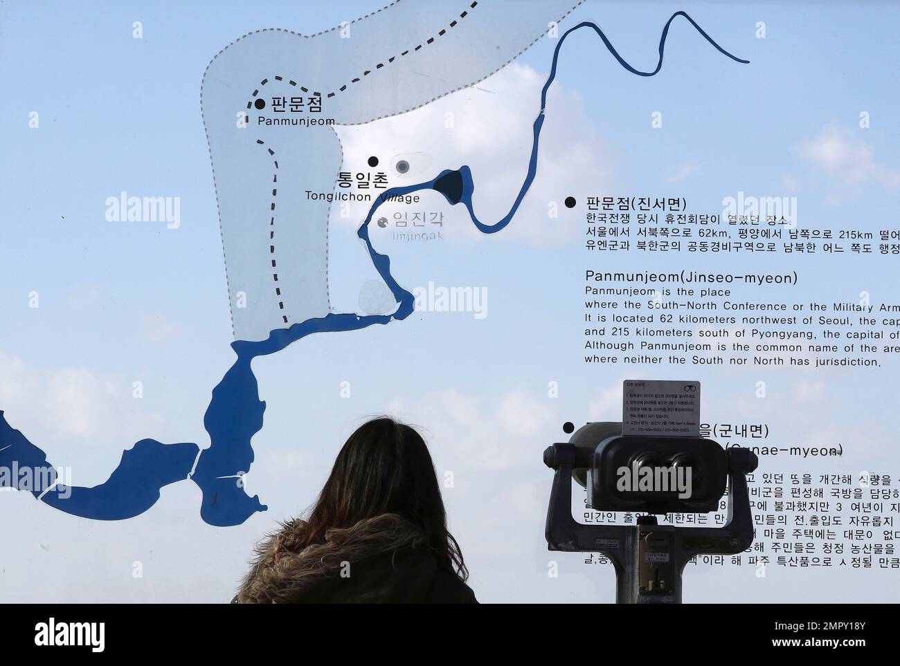 A visitor stands in front of glass showing a map of Panmunjom which has ...