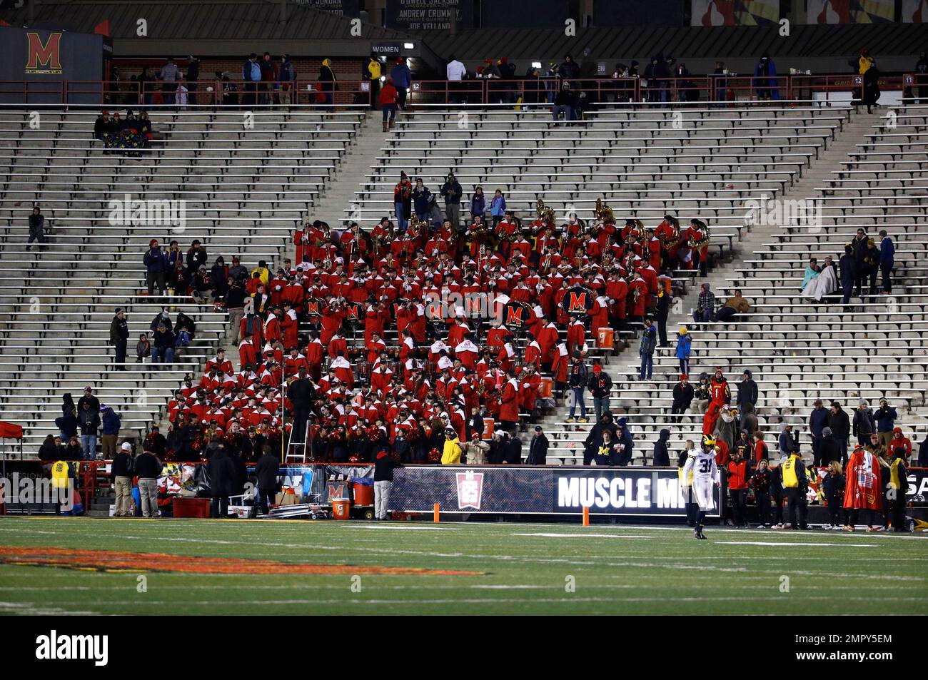 Members of the University of Maryland marching band sit in the stands ...
