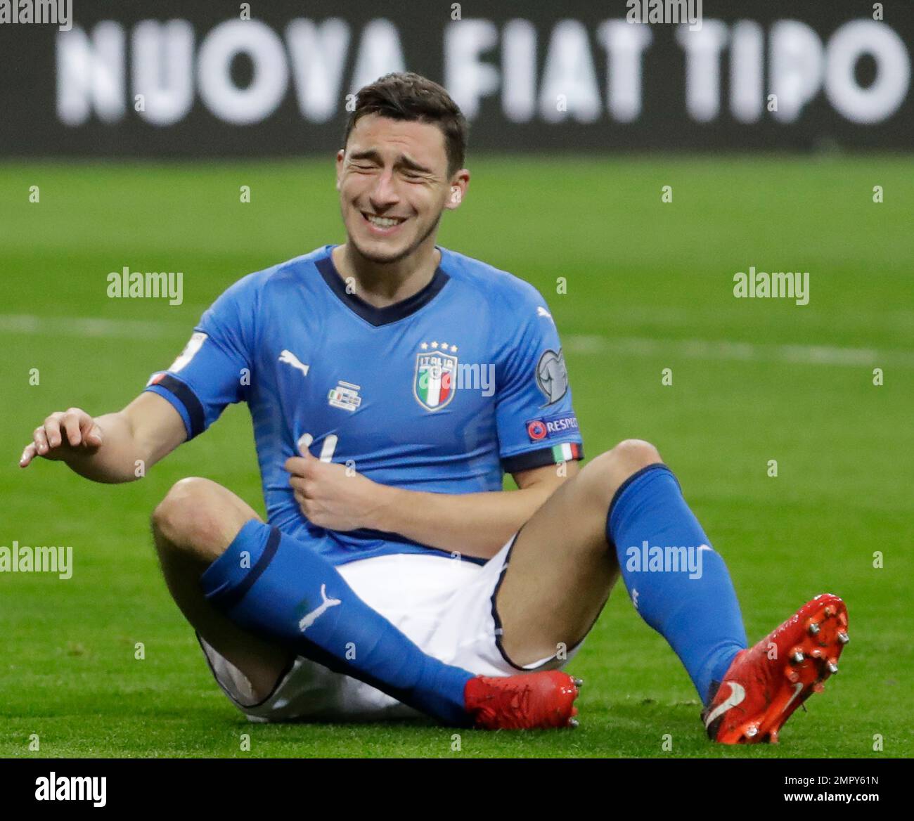 Italy's Matteo Darmian holds his chest after colliding with a Swedish ...