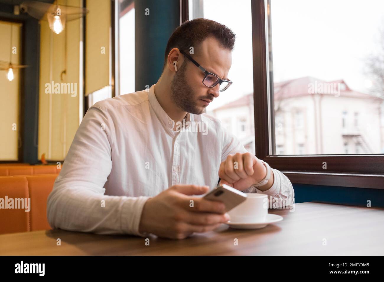 Stylish business, busy young guy of European appearance in glasses ...