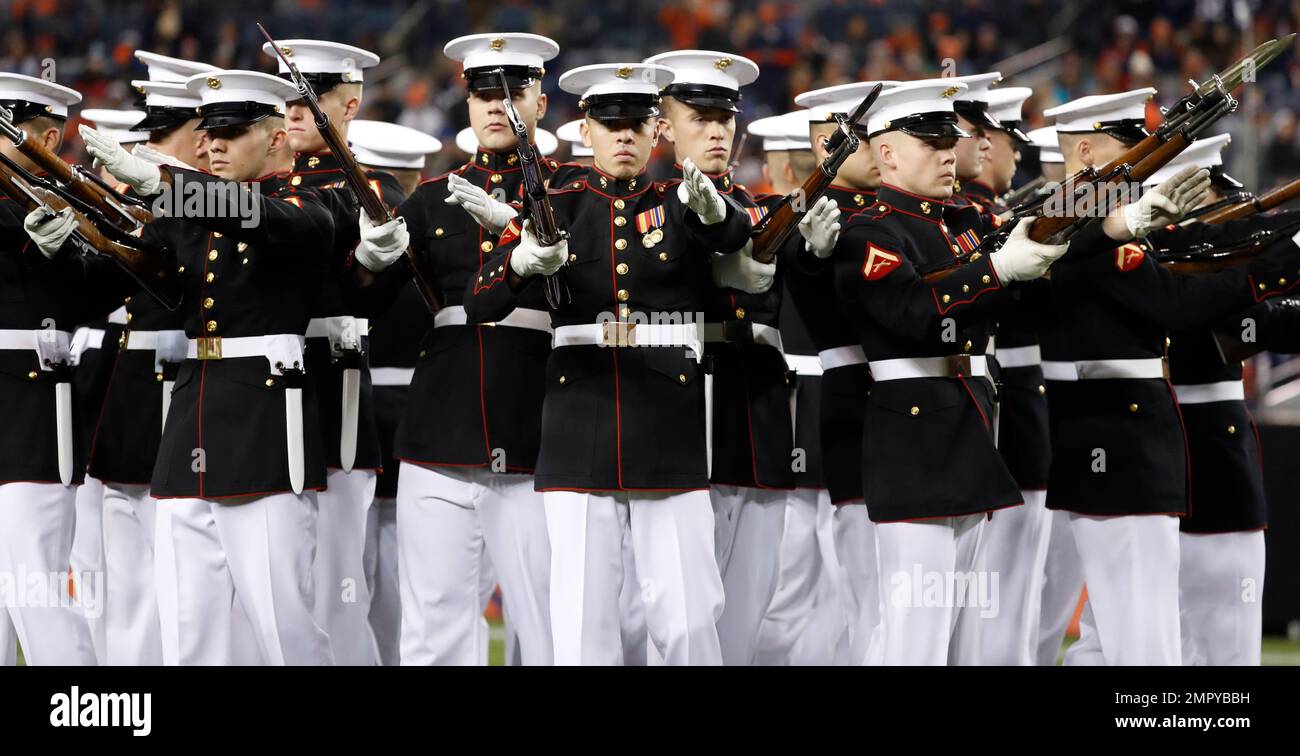 The U.S. Marines perform during half time of an NFL football game ...