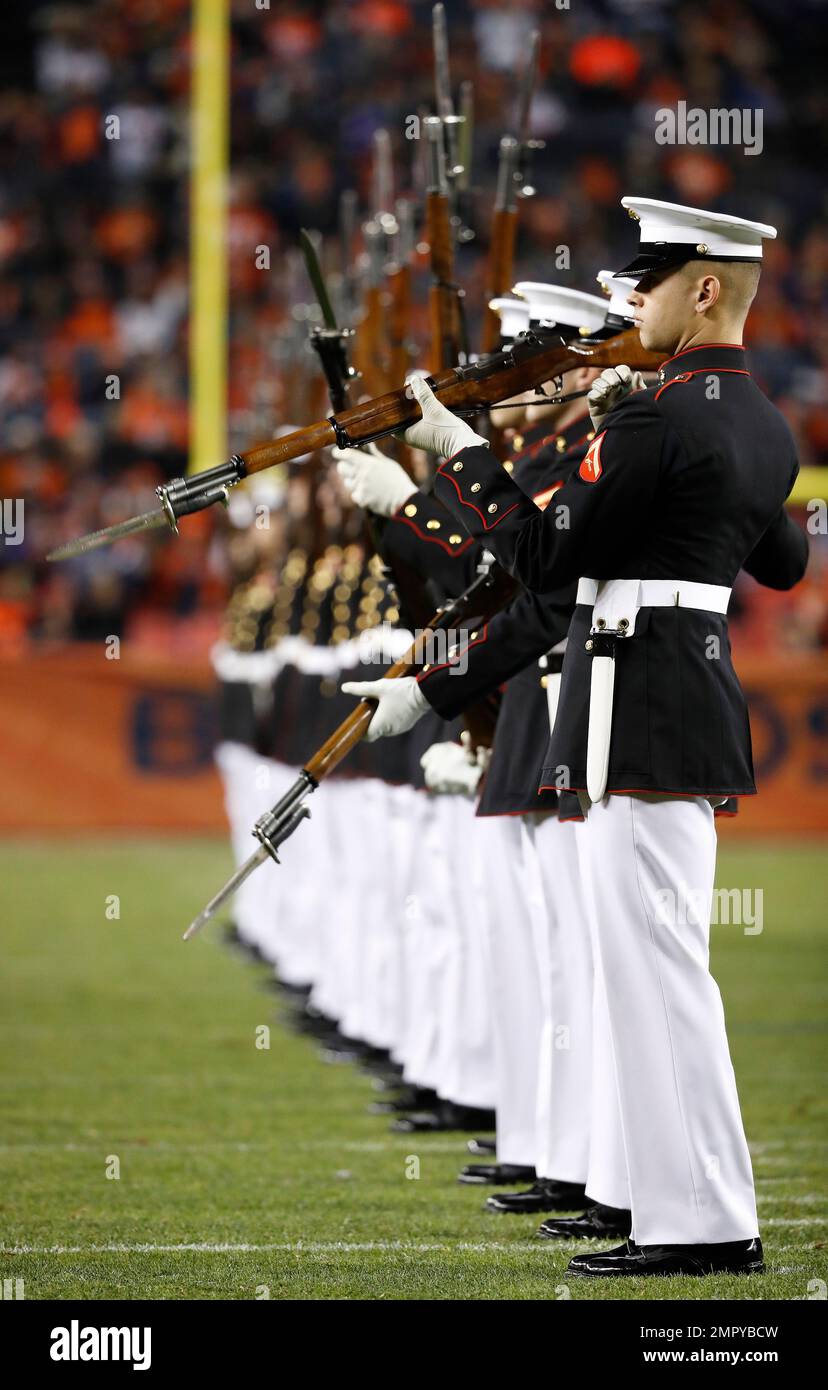 The U.S. Marines perform during half time of an NFL football game ...