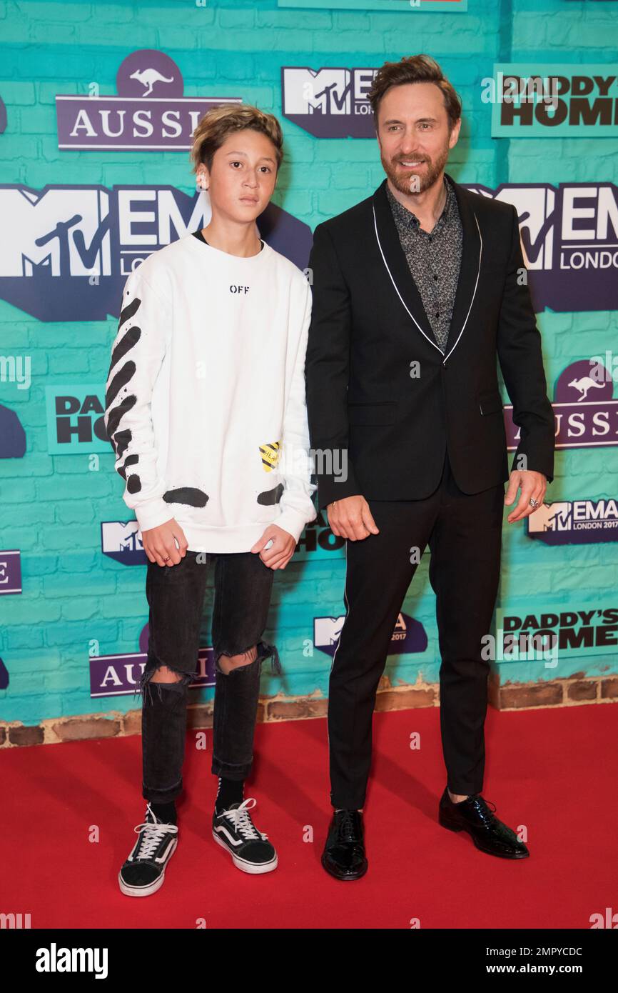 French DJ David Guetta, right, poses for photographers with his son ...