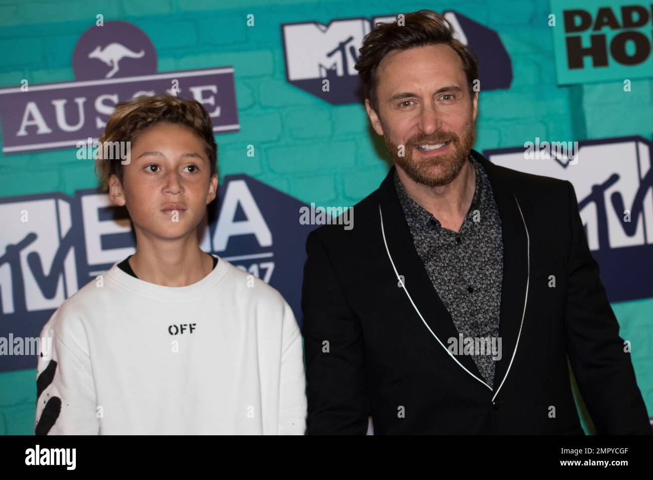 French DJ David Guetta, right, poses for photographers with his son ...