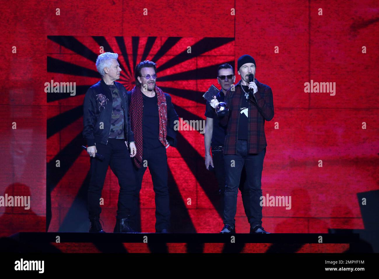 Members of the band U2, Adam Clayton, from left, Bono, Larry Mullen Jr ...