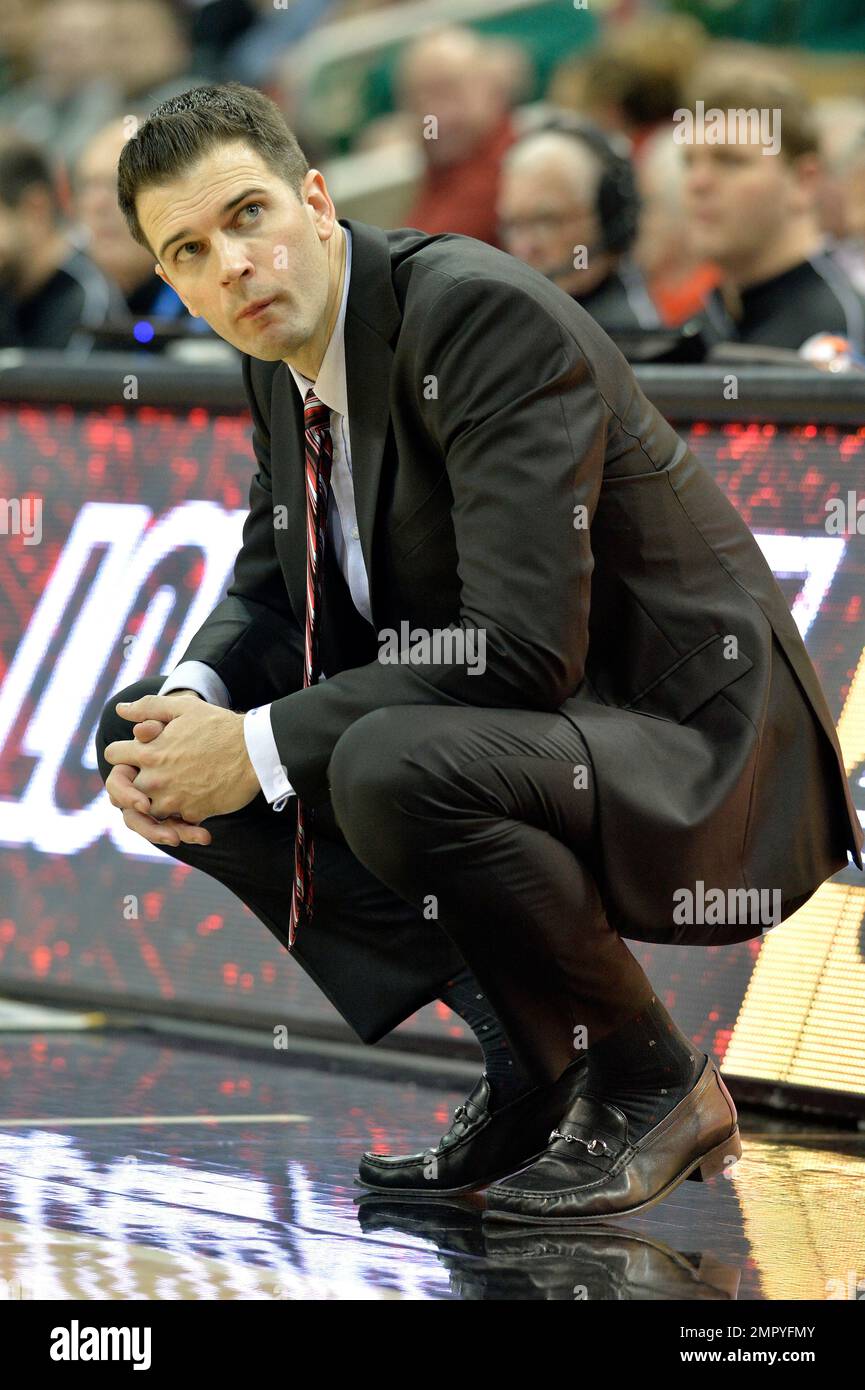Louisville interim head coach David Padgett checks the time remaining ...