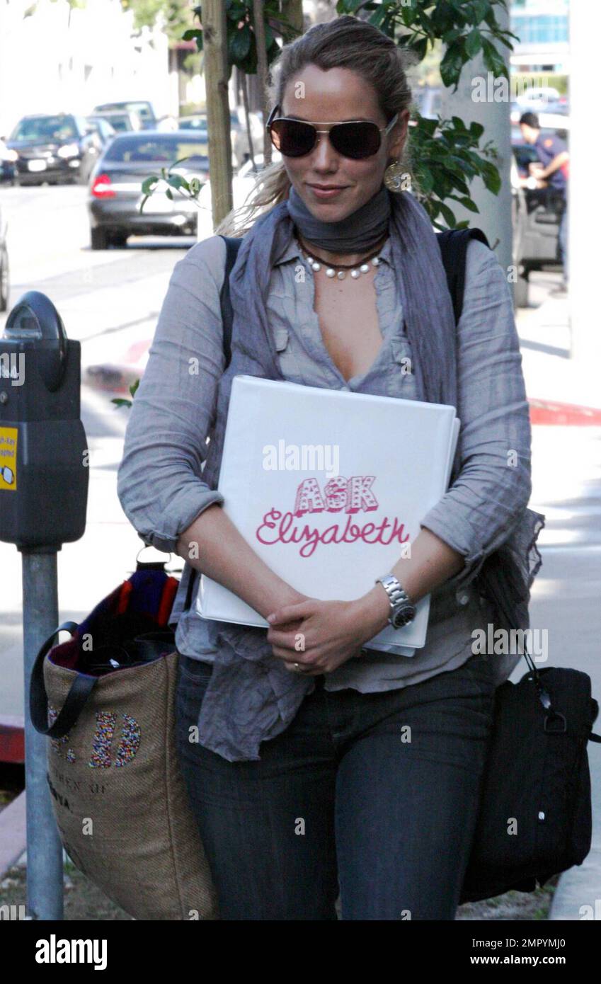Former "Saved by the Bell" actress Elizabeth Berkley clutches her "Ask ...