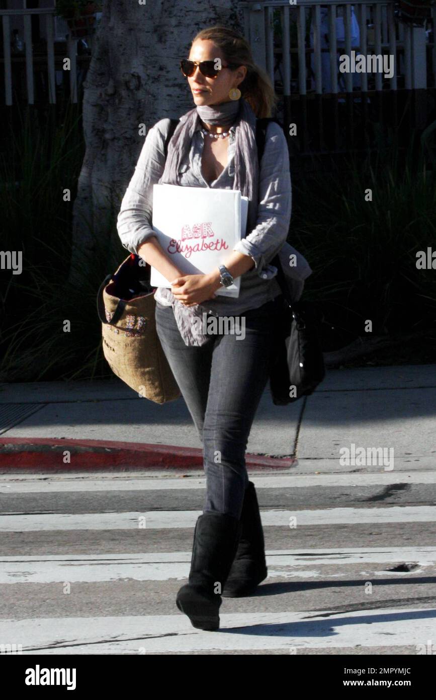 Former "Saved by the Bell" actress Elizabeth Berkley clutches her "Ask ...