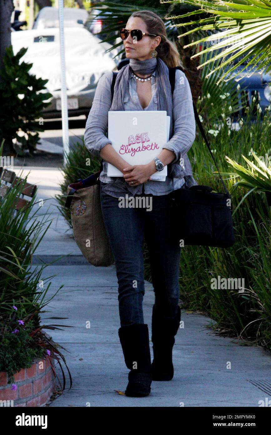 Former "Saved by the Bell" actress Elizabeth Berkley clutches her "Ask ...