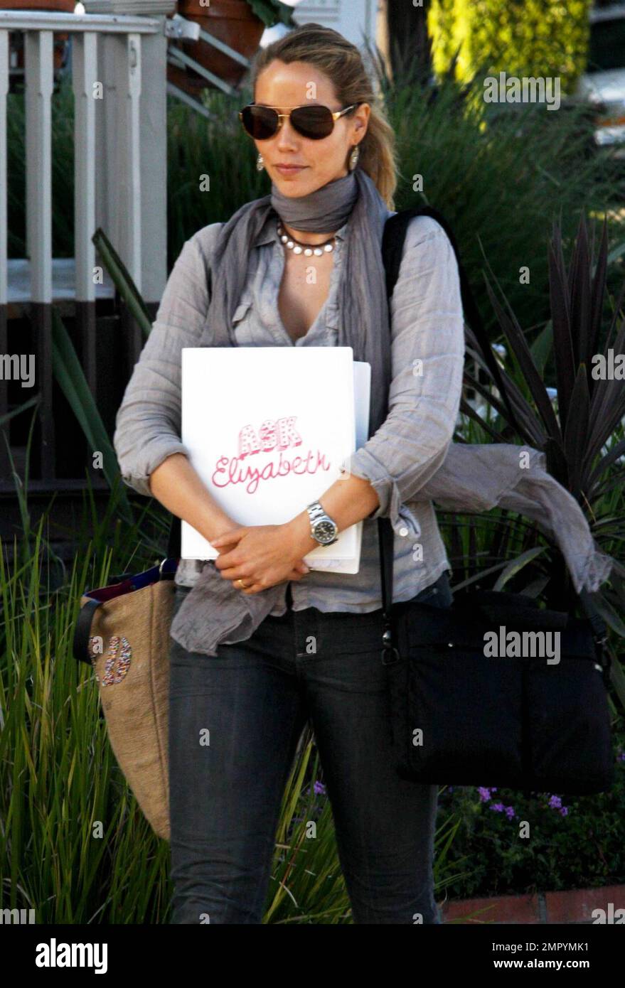 Former "Saved by the Bell" actress Elizabeth Berkley clutches her "Ask ...