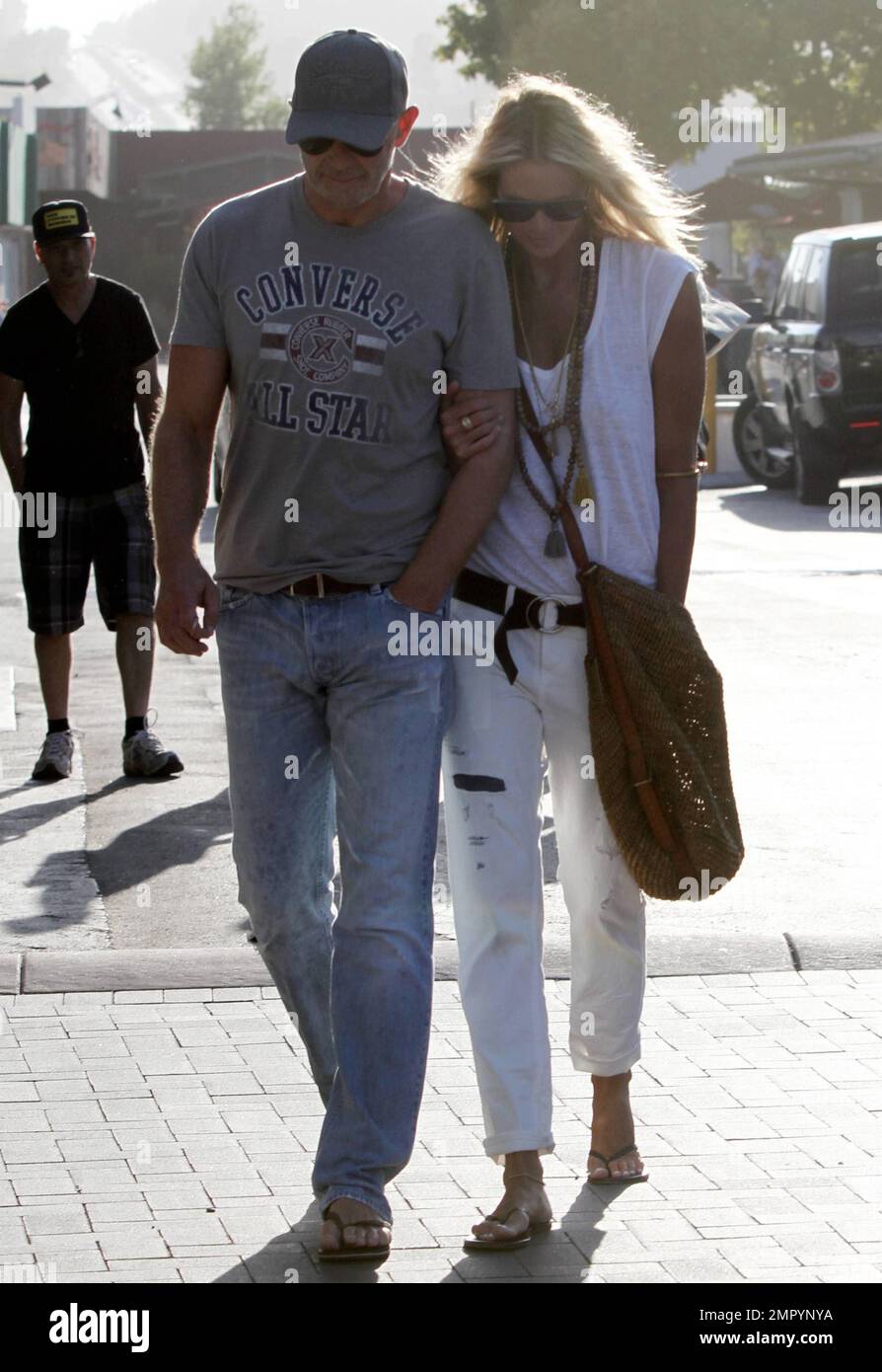Elle Macpherson held on to her boyfriend Roger Jenkins' arm as they ...