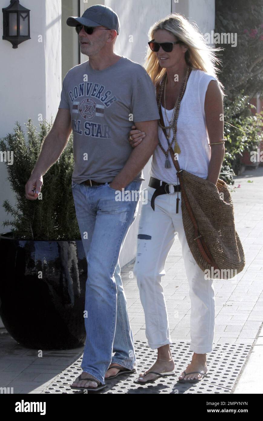 Elle Macpherson held on to her boyfriend Roger Jenkins' arm as they ...
