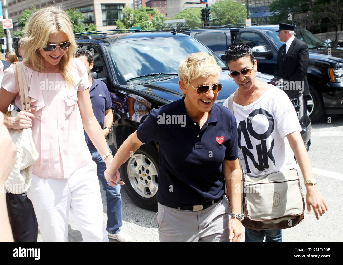 Ellen DeGeneres and Portia de Rossi hold hands as they walk toward a ...