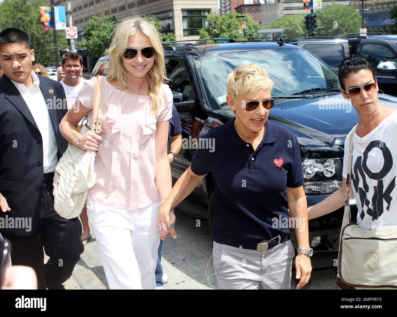 Ellen DeGeneres and Portia de Rossi hold hands as they walk toward a ...