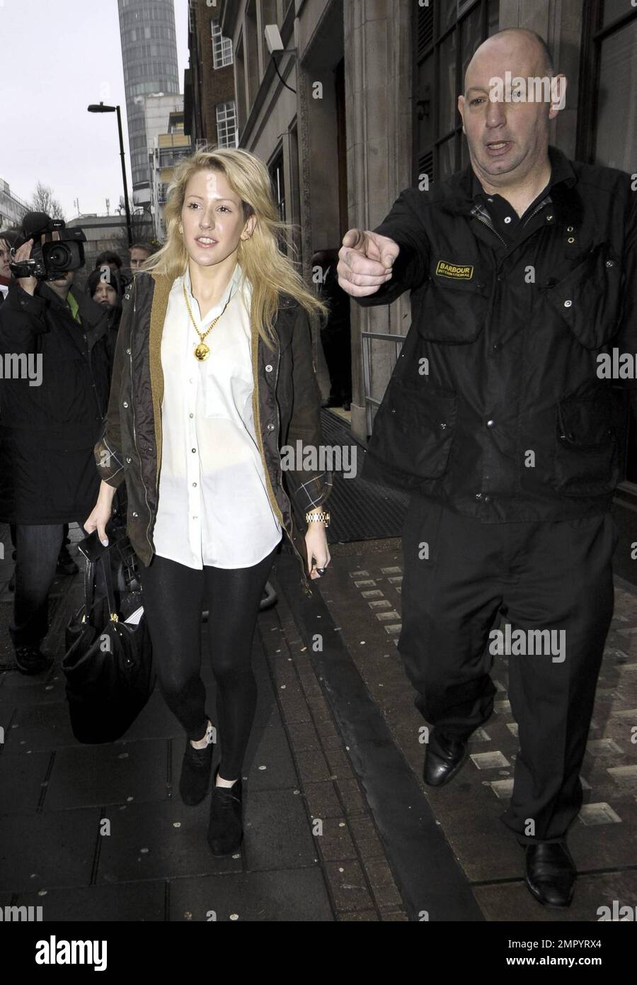 Singer/sogwriter and guitarist Ellie Goulding gets an escort past a ...