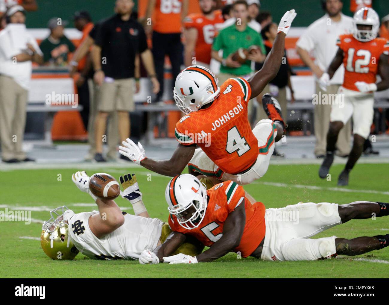 Miami defensive back Jaquan Johnson (4) and defensive back Amari Carter ...