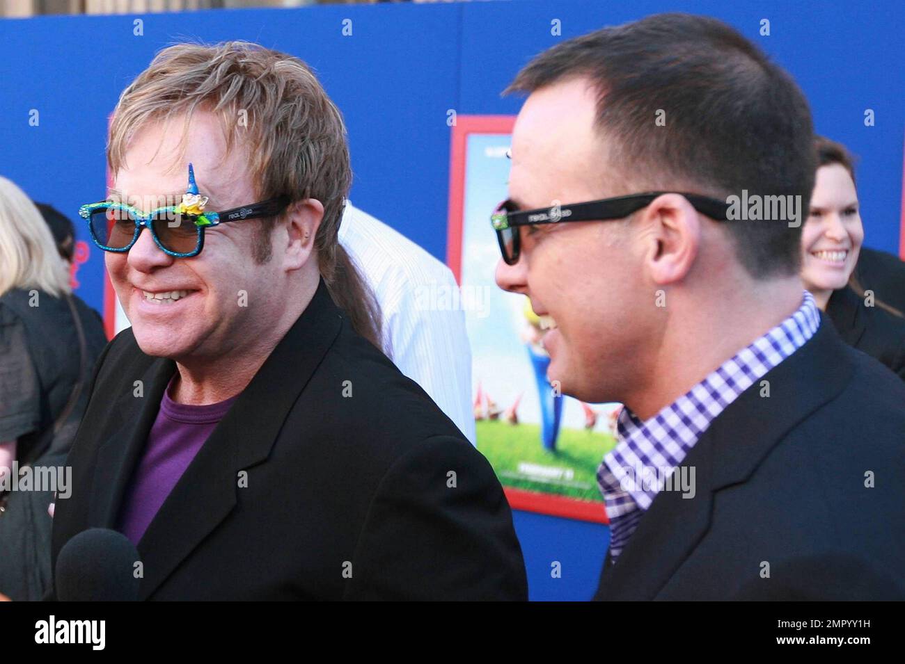 Sir Elton John and partner David Furnish appear delighted as they pose ...