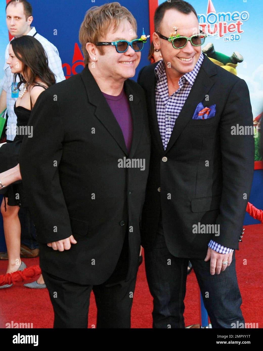 Sir Elton John and partner David Furnish appear delighted as they pose ...