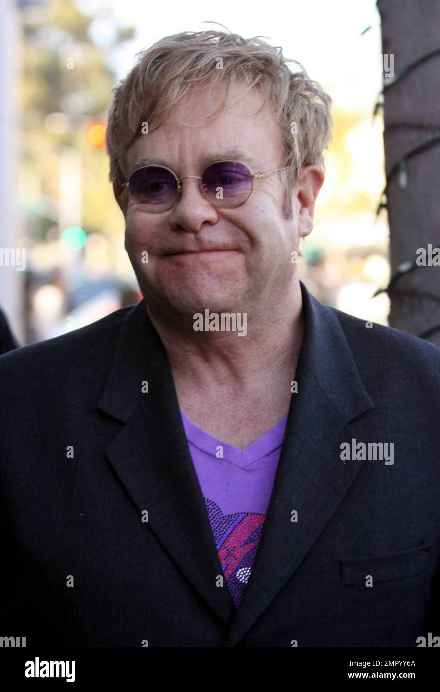 Musician Elton John grins as he leaves the restaurant E Baldi on ...