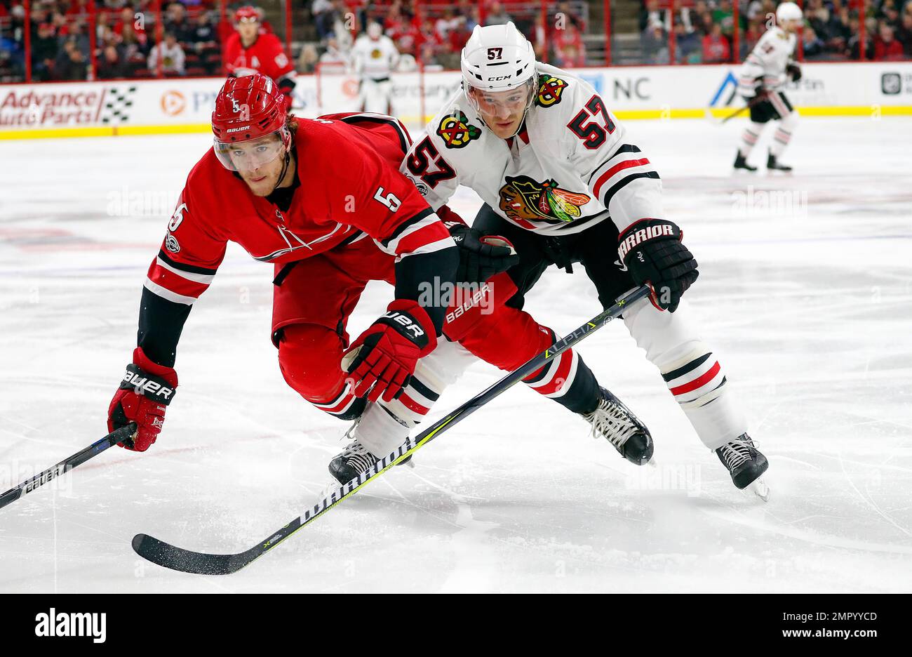 Carolina Hurricanes' Noah Hanifin (5) battles with Chicago Blackhawks ...