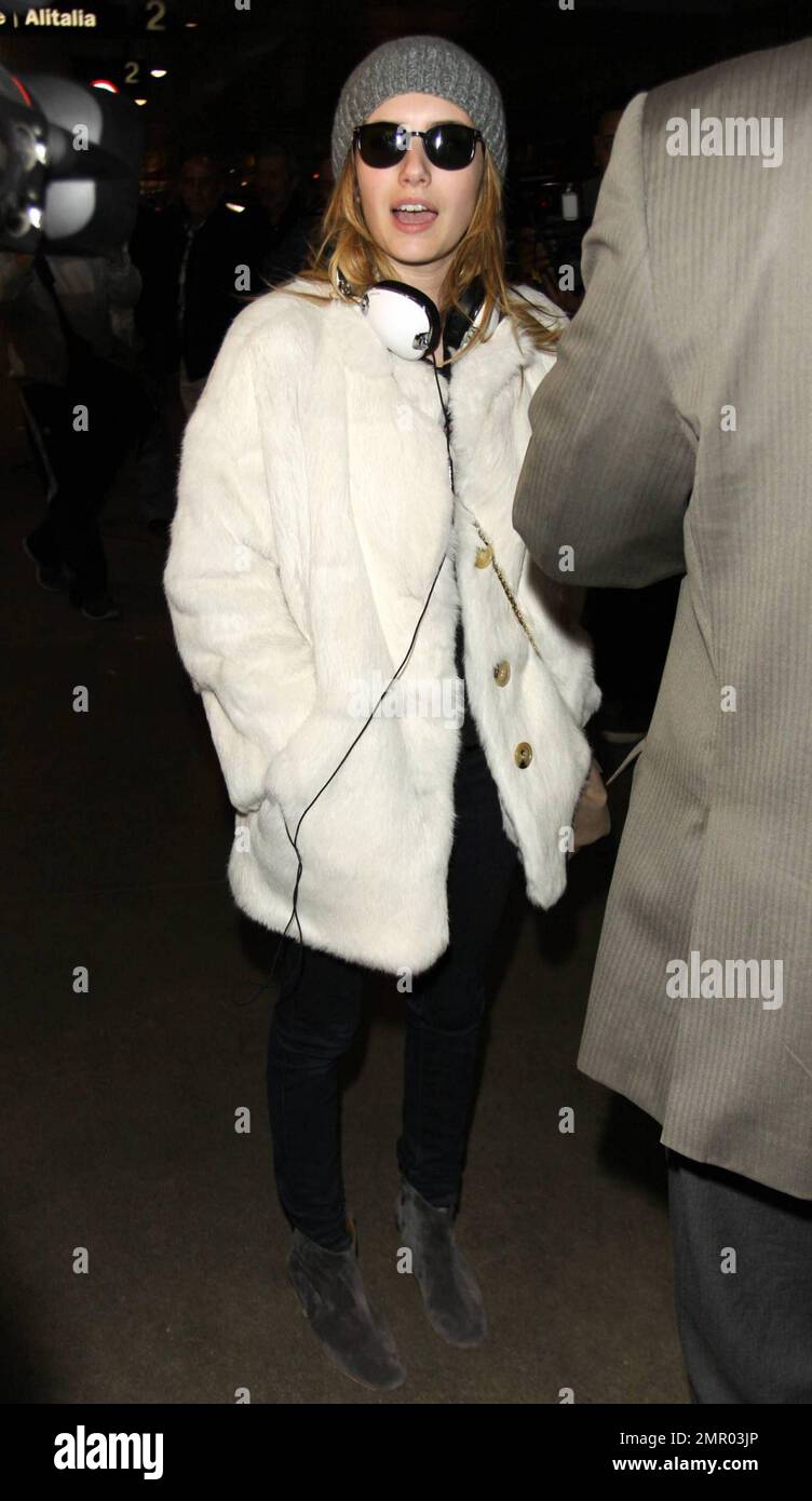 Actress Emma Roberts looks warm in a white fuzzy coat and grey hat as ...