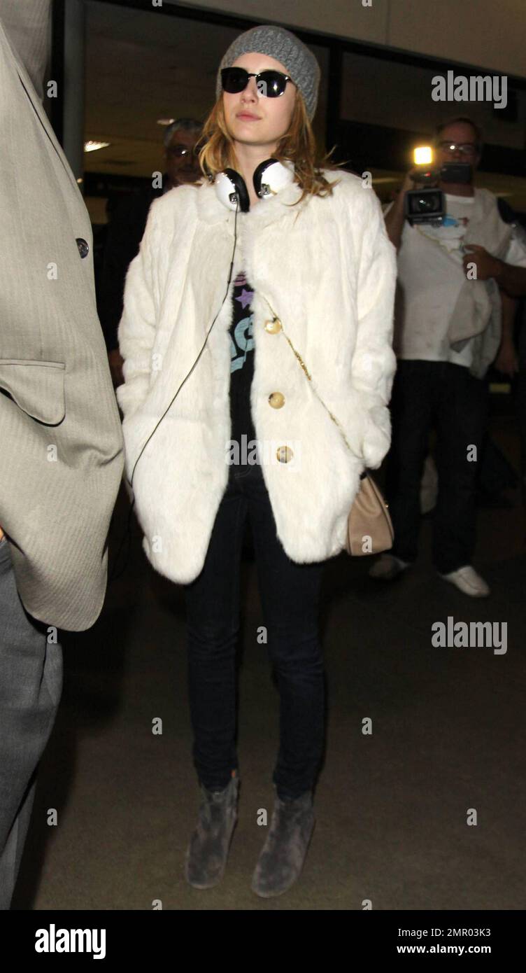 Actress Emma Roberts looks warm in a white fuzzy coat and grey hat as ...